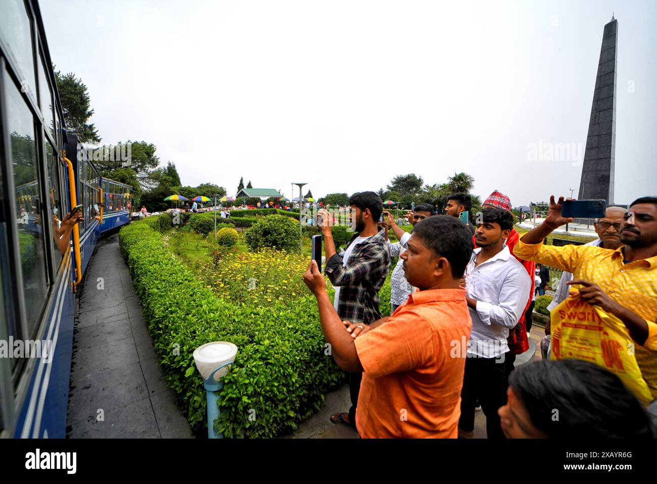 People take pictures of a Toy Train near Batasia Loop of Darjeeling ...