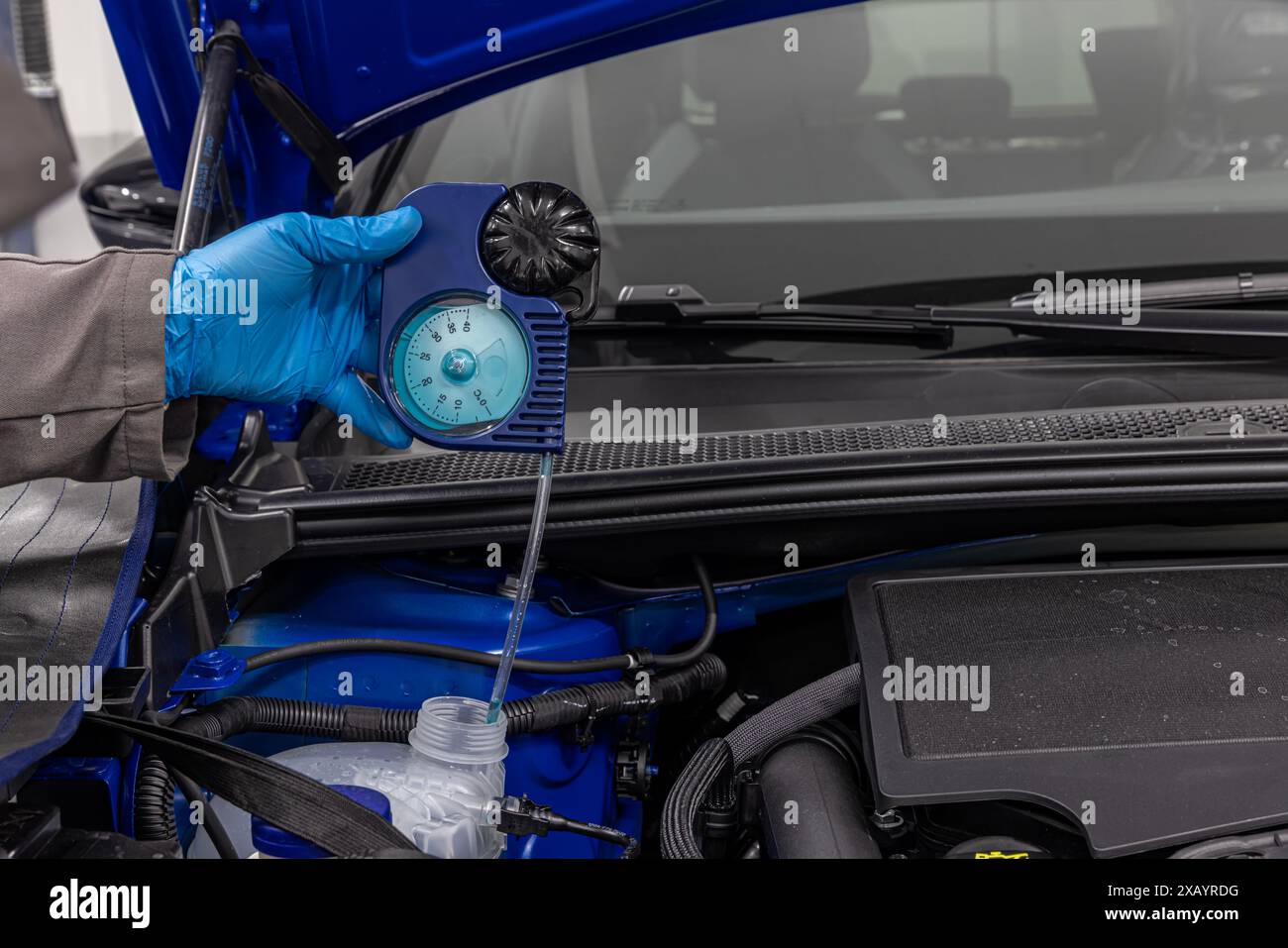 Car winter maintenance antifreeze control. Automobile mechanic tests ...