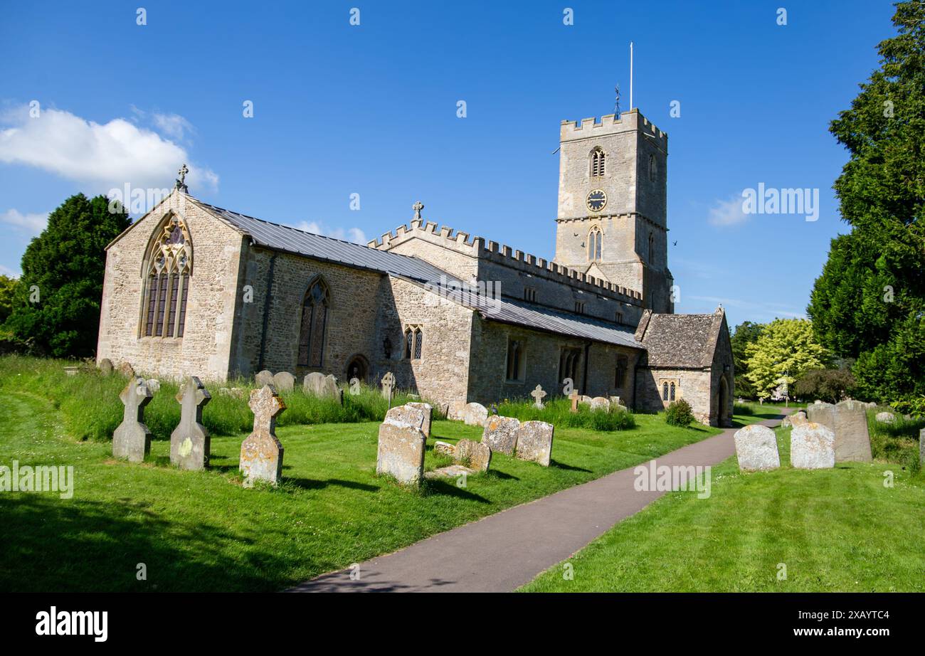 St Denys church, with tower surrounded by a graveyard and lush greenery ...