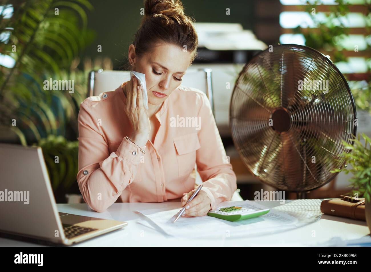 Sustainable workplace. modern female employee in modern green office ...