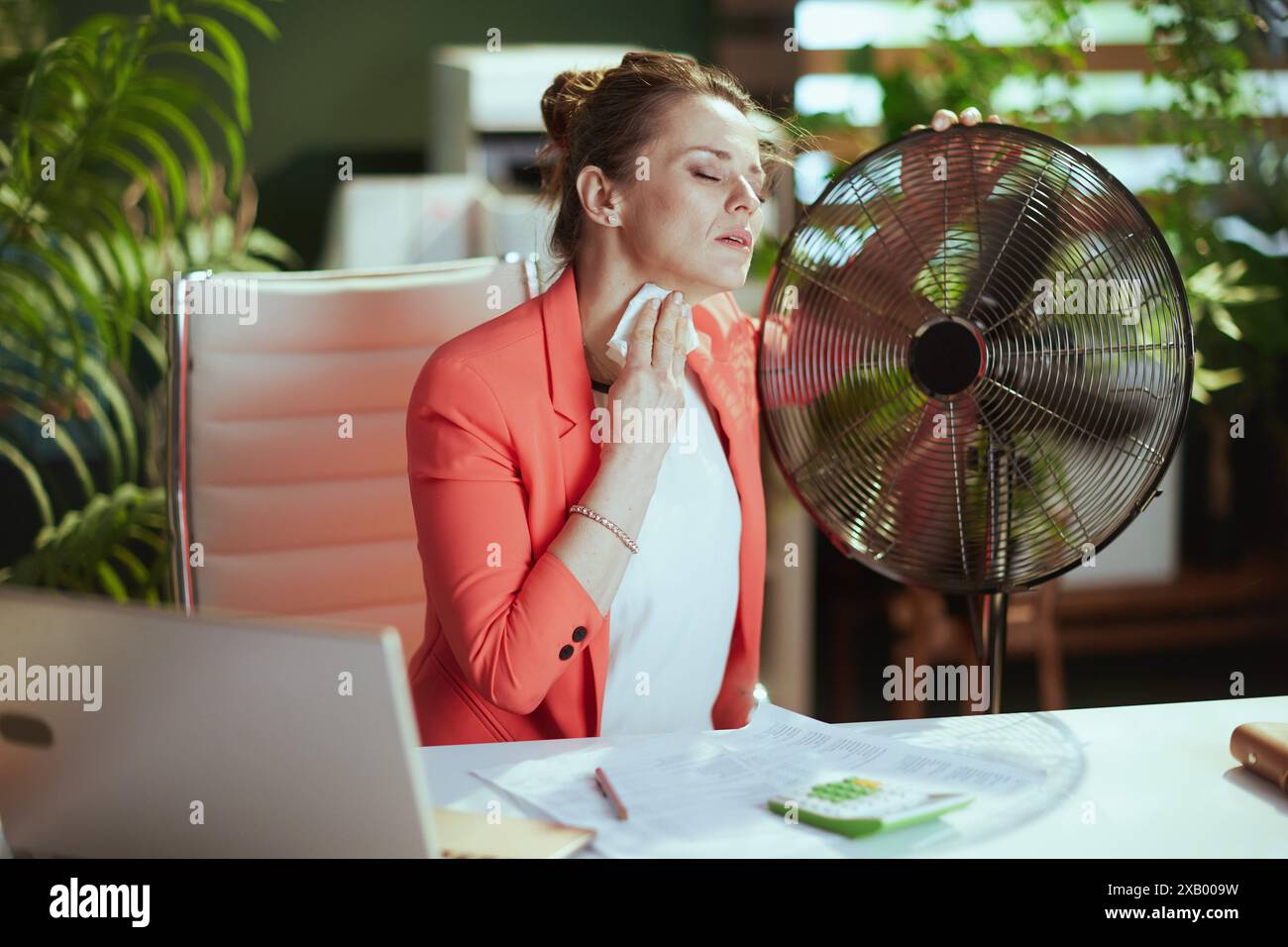 Sustainable workplace. modern 40 years old woman worker at work in red ...