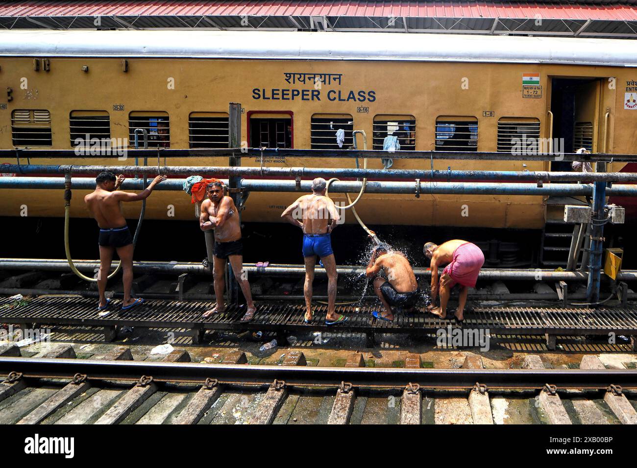 People seen taking a bath next to a sleeper class train at New ...
