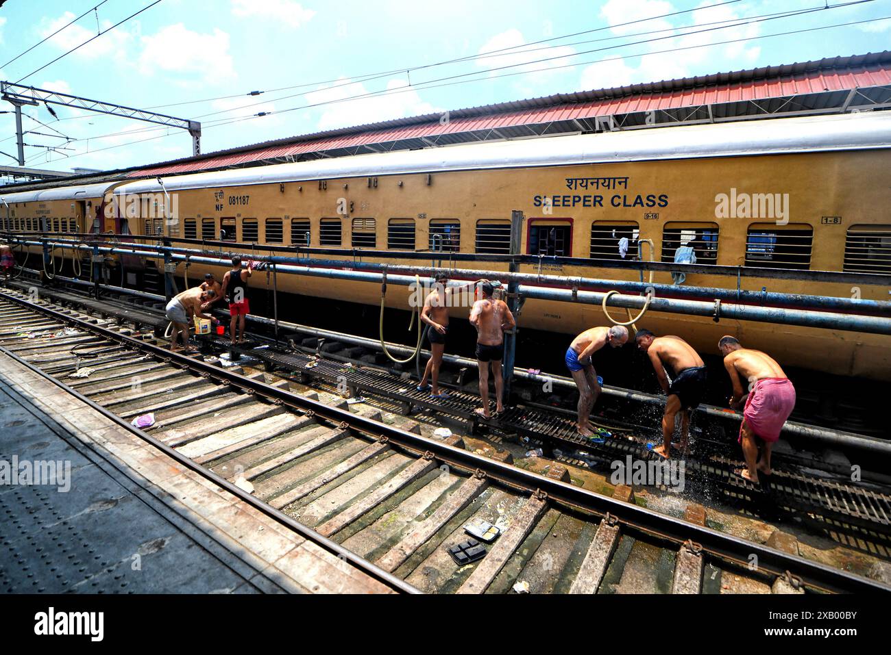 People seen taking a bath next to a sleeper class train at New ...