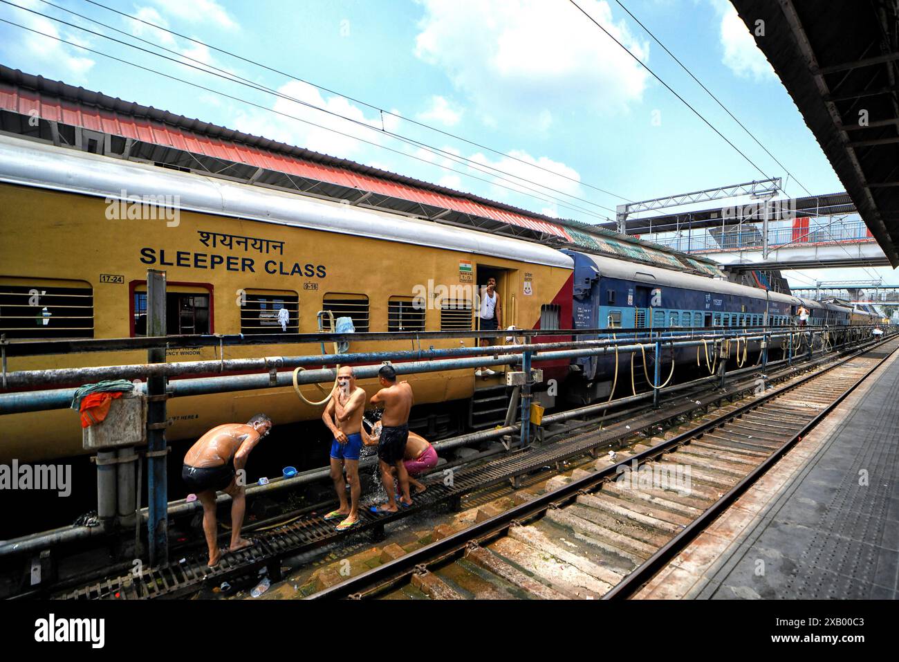 People seen taking a bath next to a sleeper class train at New ...