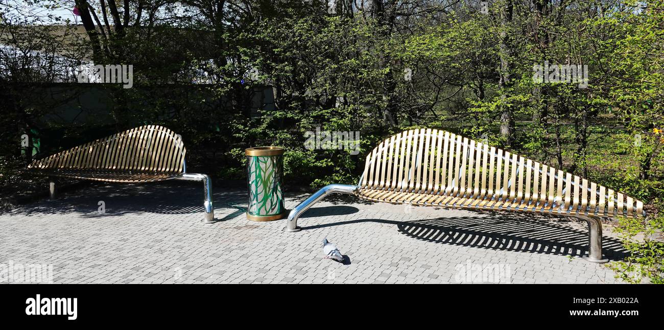 Kyiv, Ukraine April 11, 2024: Gilded bench in the summer park of the ...