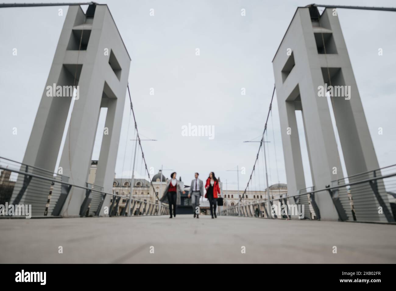 Business partners walking and discussing on a modern bridge Stock Photo ...