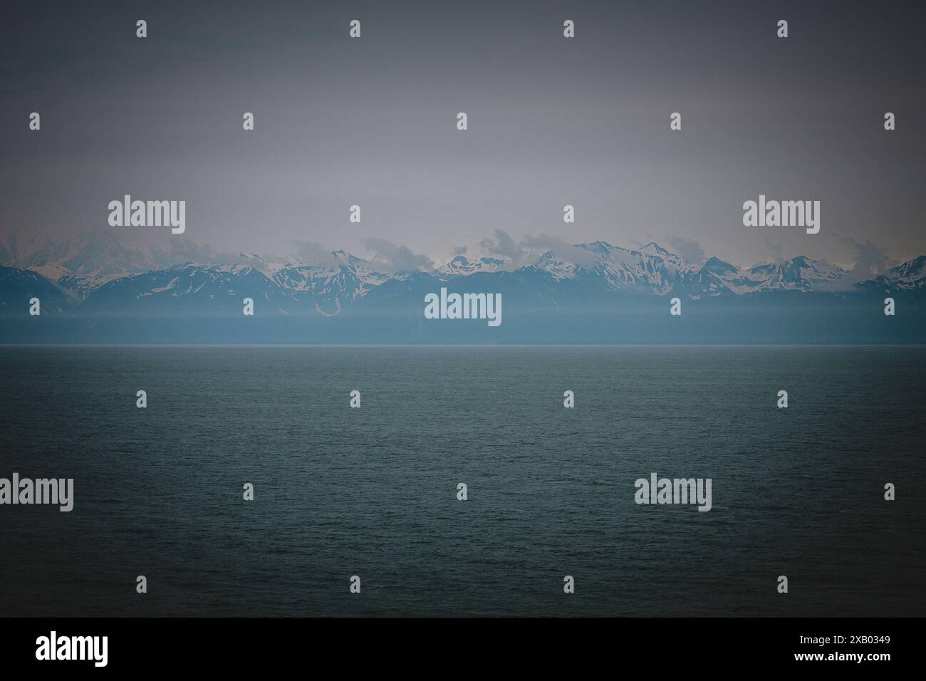 A stunning view of the expansive Alaskan coastline with snow-capped ...