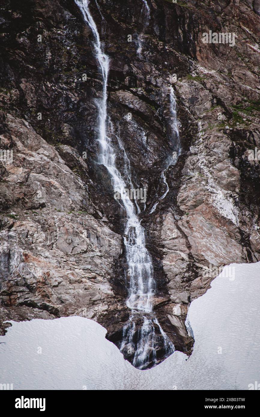 A stunning close-up of a waterfall cascading down the rugged, icy ...