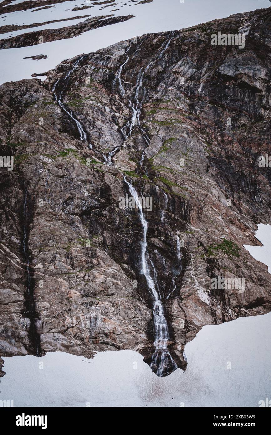 This stunning shot captures a cascading waterfall tumbling down rugged ...