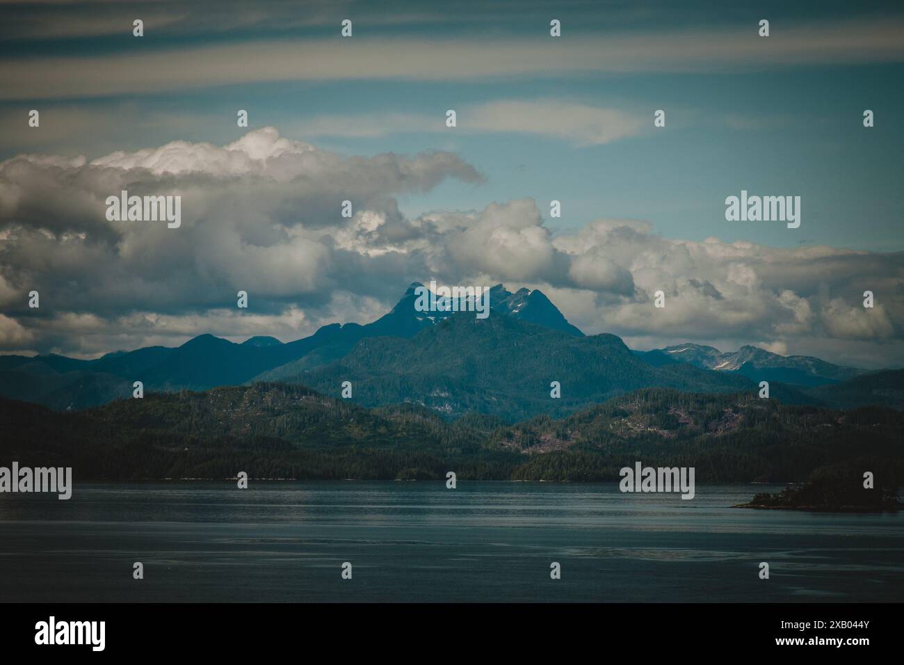 A stunning view of Alaska's rugged mountains beneath dramatic, cloud ...