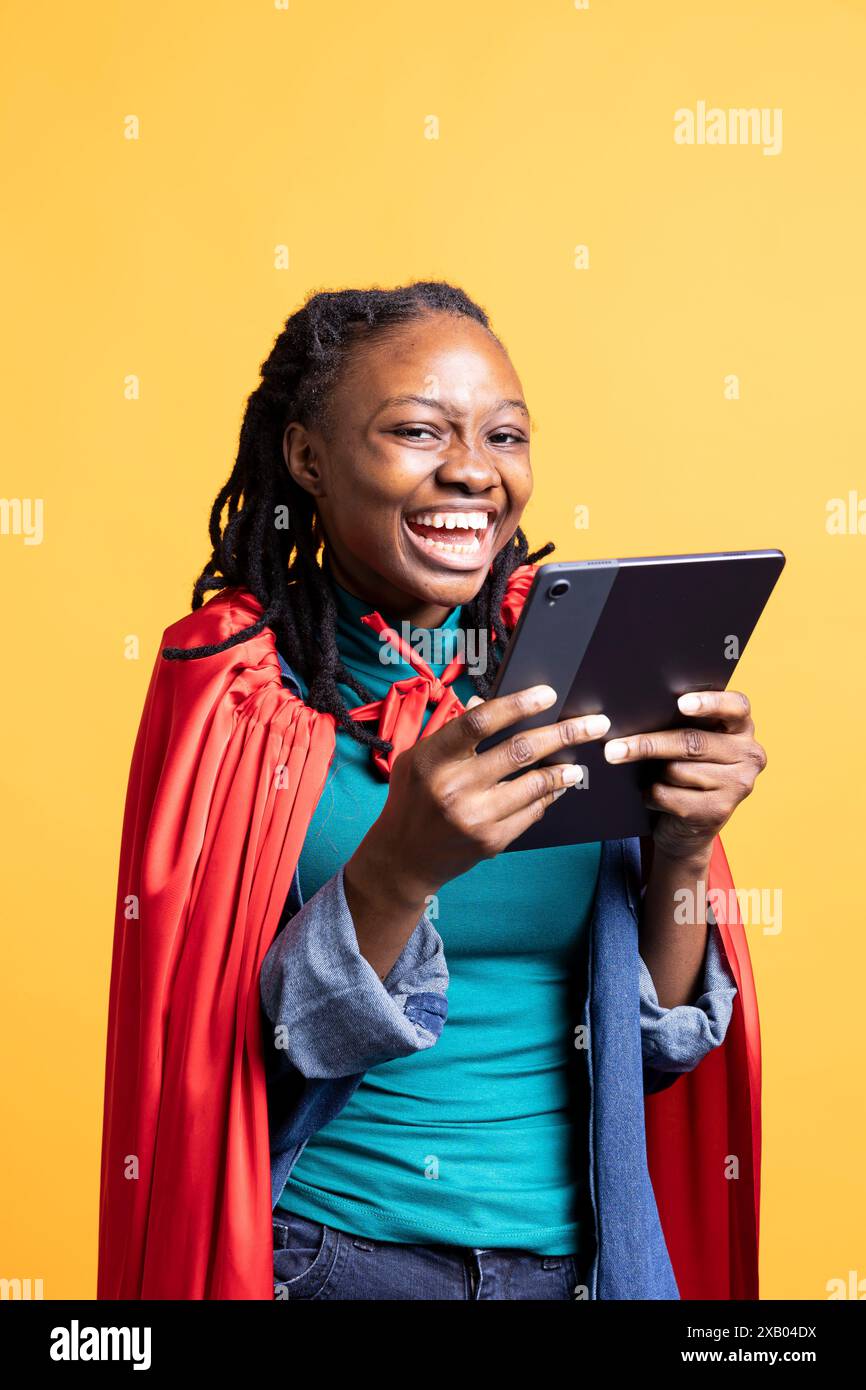 Overjoyed girl laughing while wearing superhero costume for Halloween ...