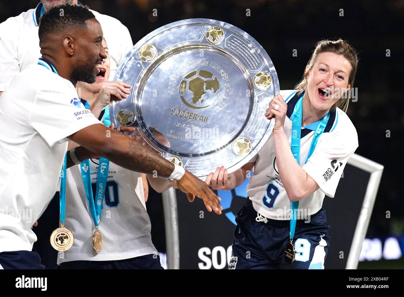 England's Ellen White (right) lifts the trophy with team-mates after ...