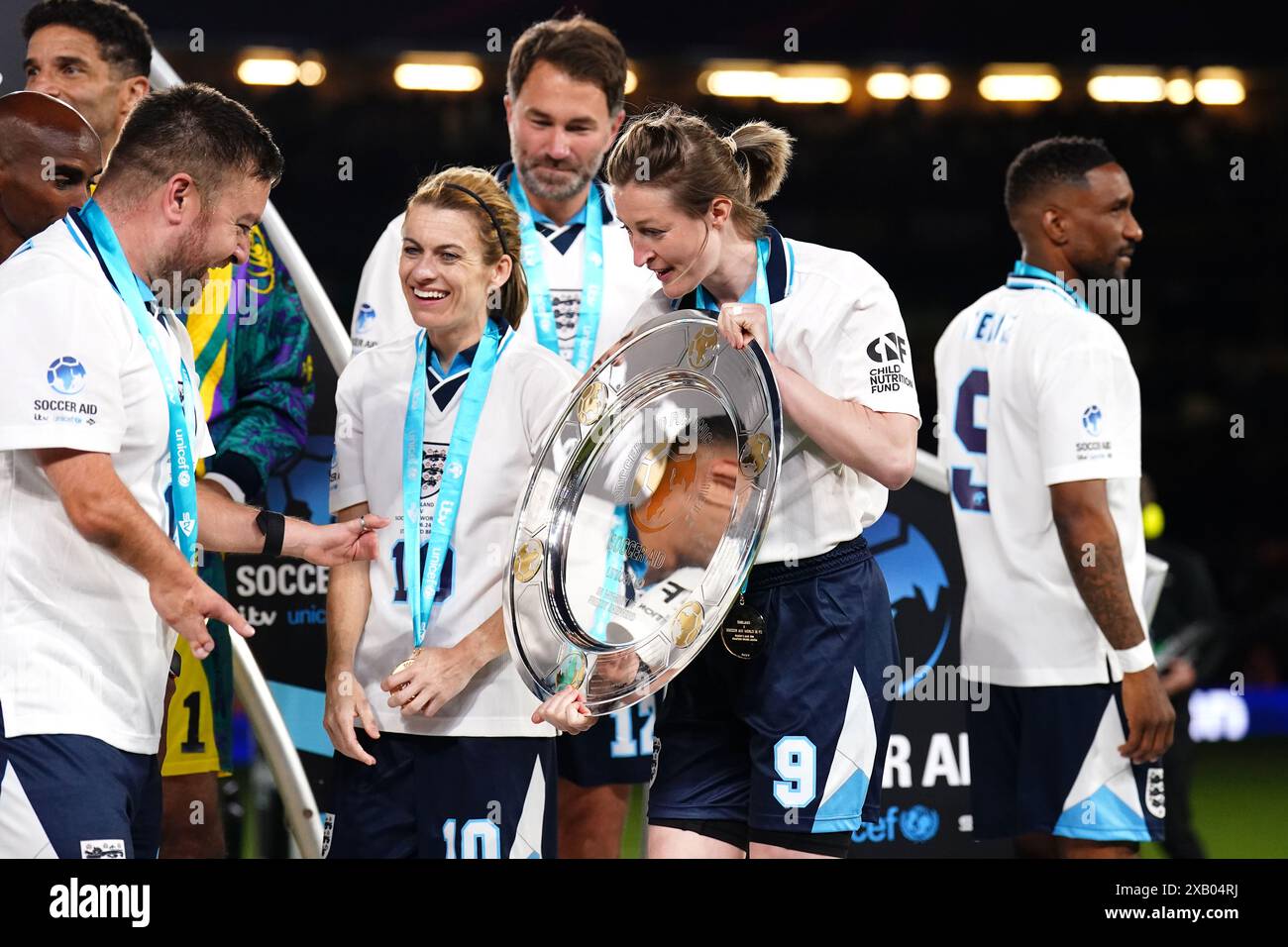 England's Ellen White (centre) lifts the trophy with team-mates after ...