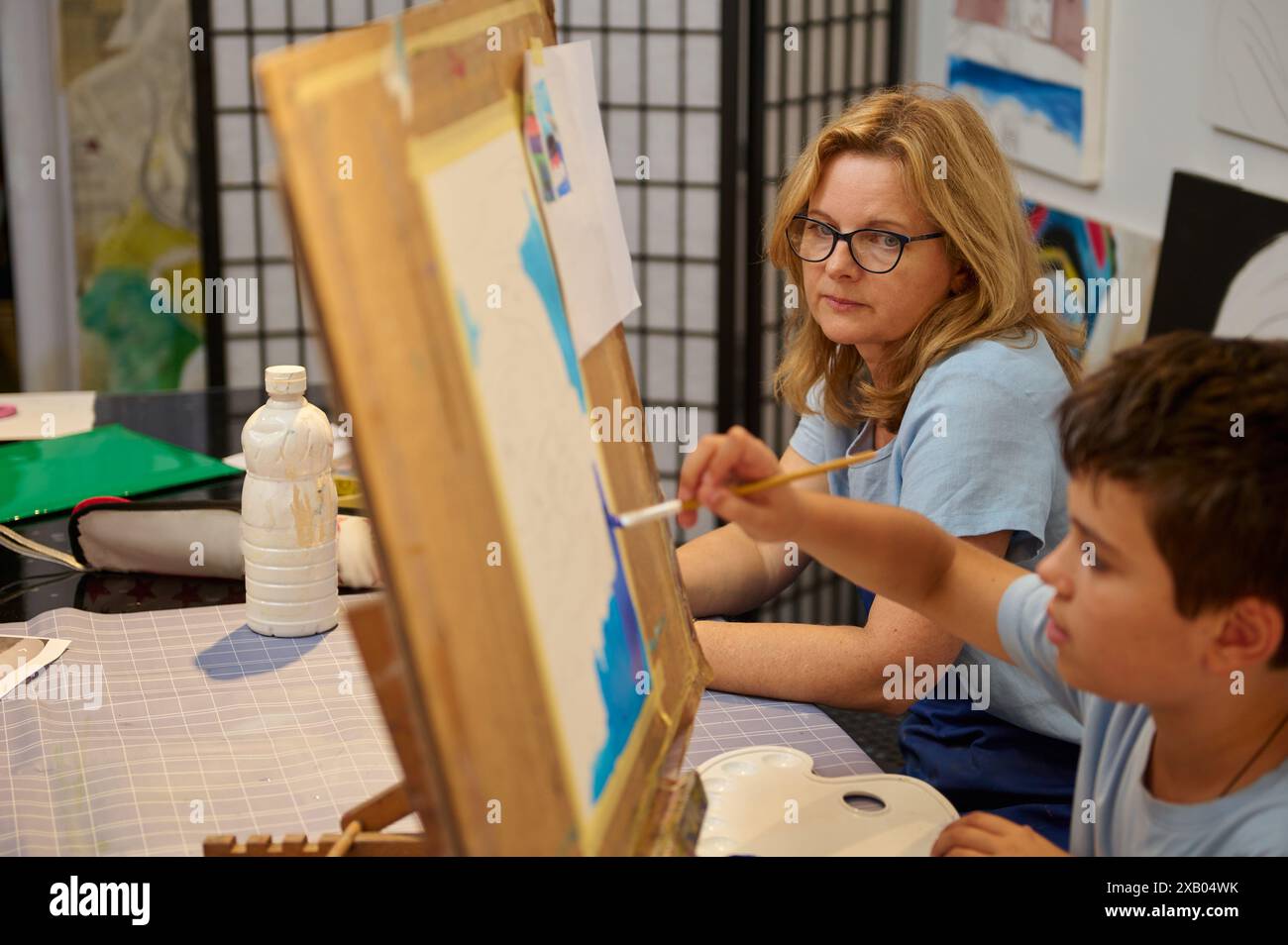 Kids have art class, drawing, painting with teacher in workshop. A ...