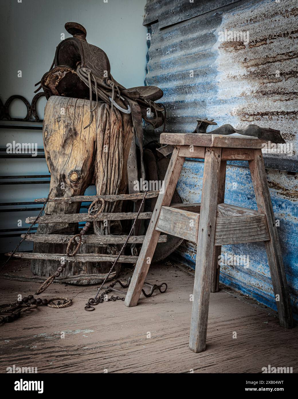 Still-life on a ranch. Saddle and stool Stock Photo - Alamy