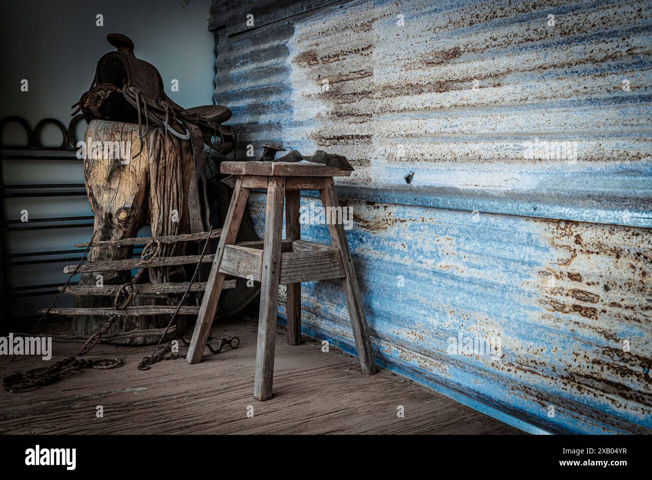 Still-life on a ranch. Saddle and stool Stock Photo - Alamy