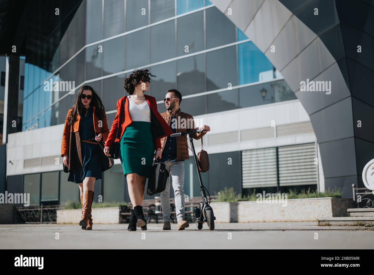 Businesspeople walking together in an urban city area, discussing work ...