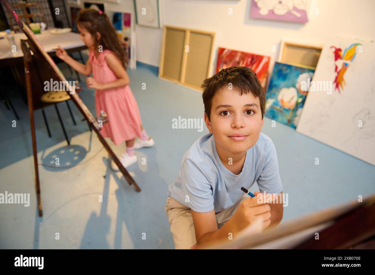 Kids have art class, drawing, painting with teacher in workshop. The ...