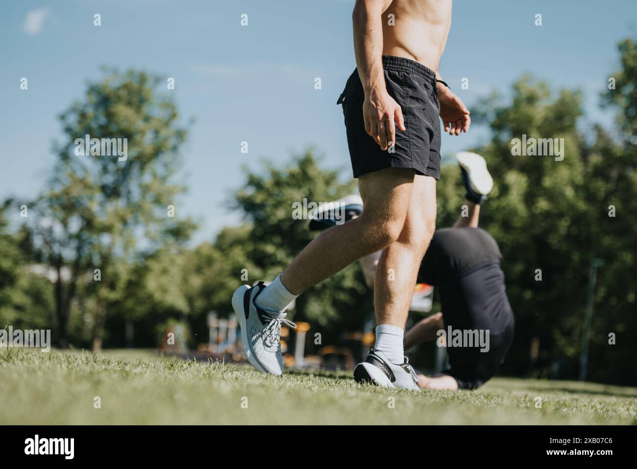 Outdoor exercise in an urban park with two people enjoying a workout ...