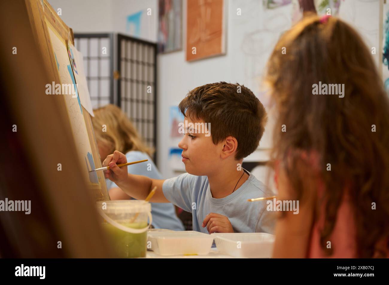 Kids have art class, drawing, painting with teacher in workshop. Young ...
