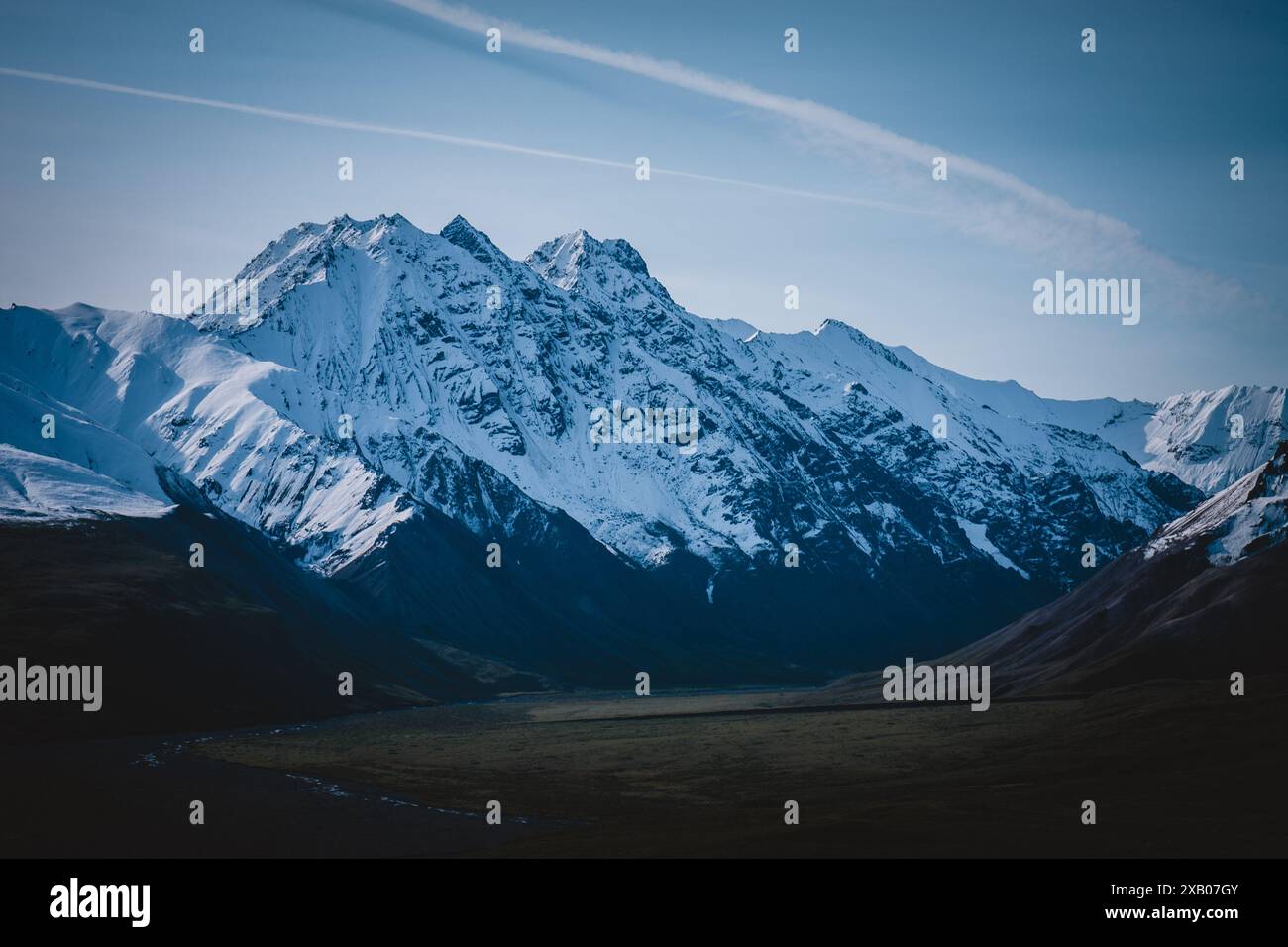 Immerse in the awe-inspiring beauty of Alaska's snow-capped peaks. This ...