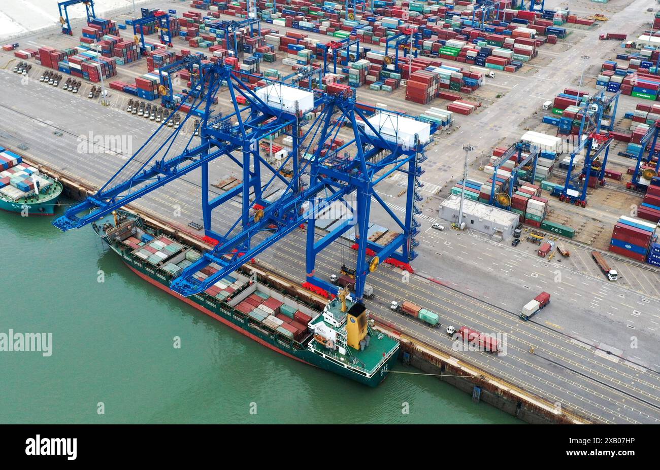 SHISHI, CHINA - JUNE 9, 2024 - Cargo ships are loaded and unloaded at ...