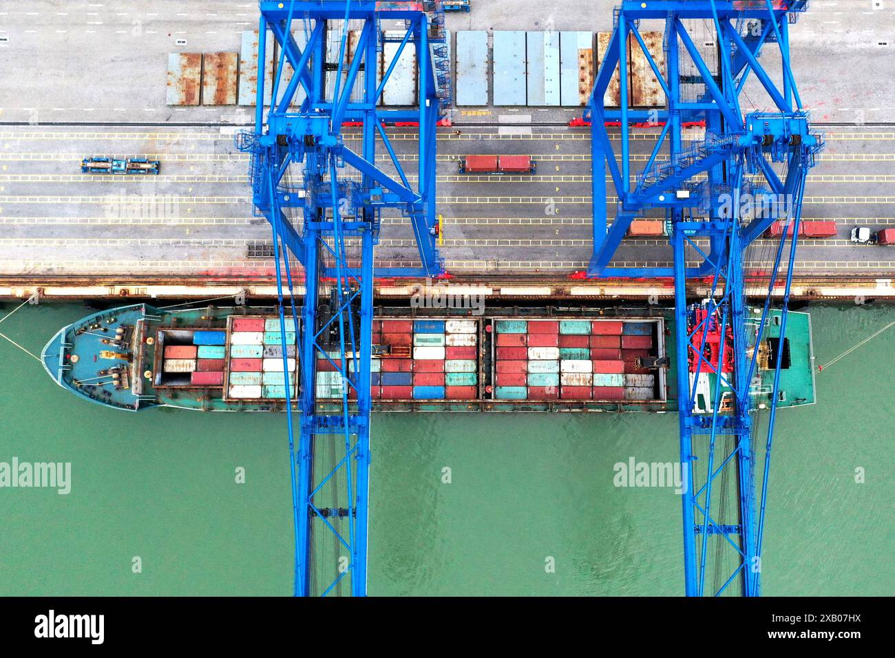 SHISHI, CHINA - JUNE 9, 2024 - Cargo ships are loaded and unloaded at ...