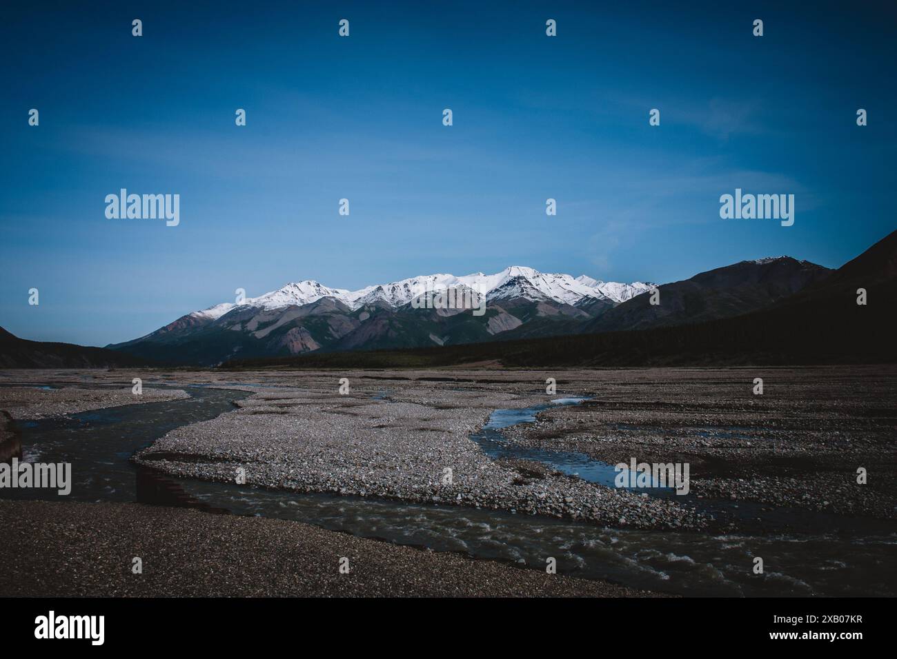 Discover the rugged beauty of Alaska's riverbeds against a backdrop of ...