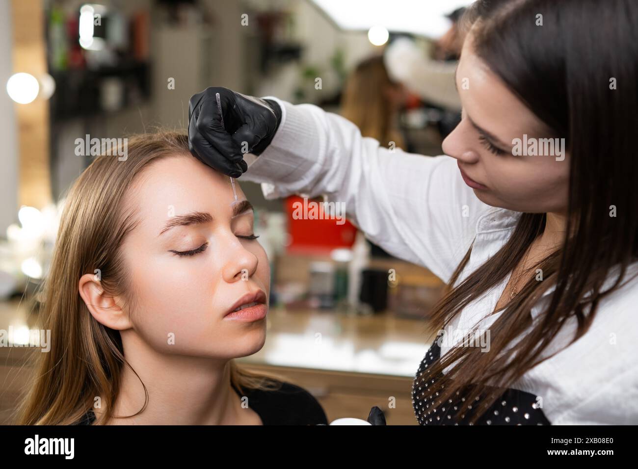 Beauty master drawing contour for brow correction Stock Photo - Alamy