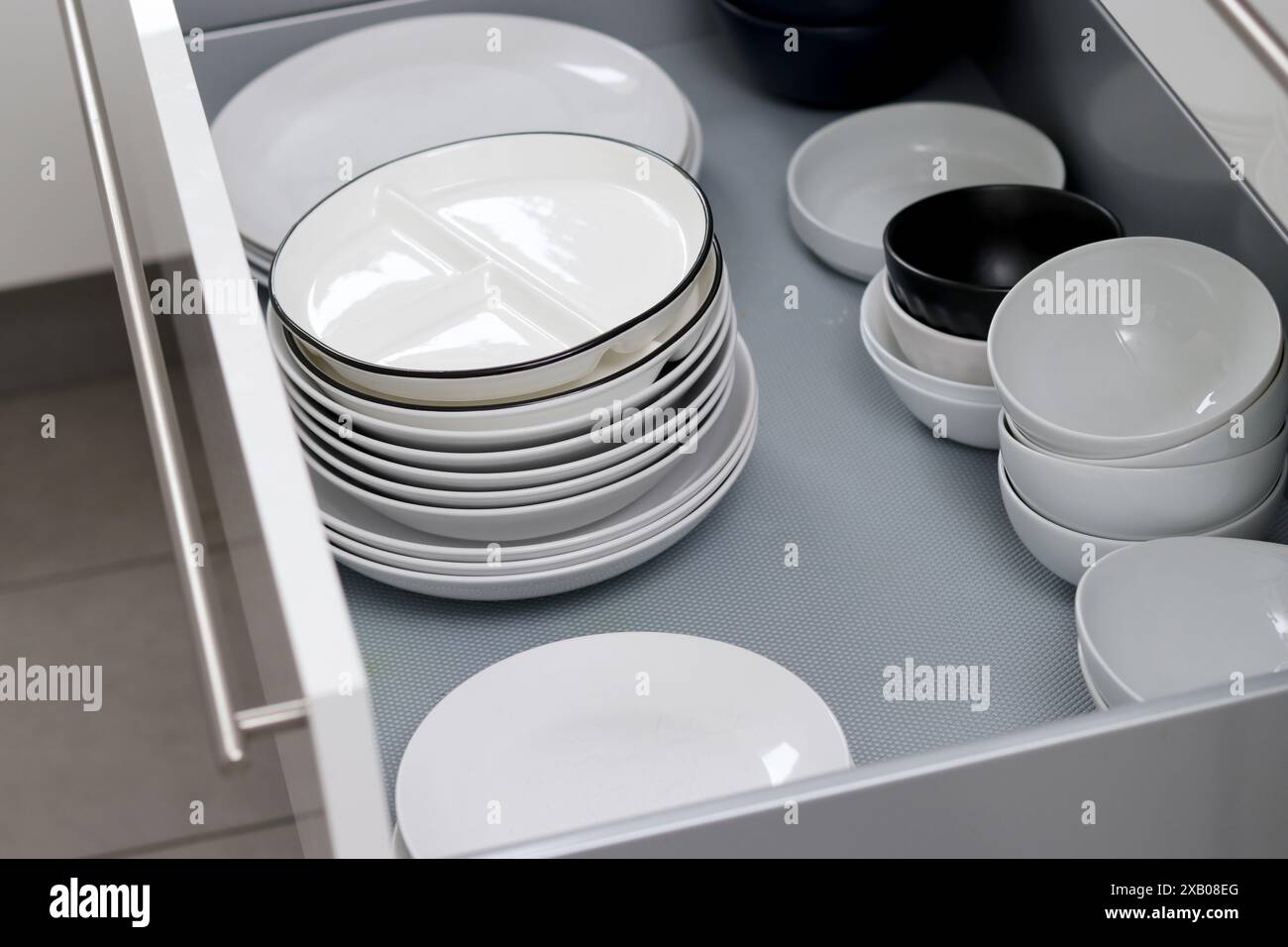 Close up of white plates and other dishes in a kitchen cabinet Stock ...