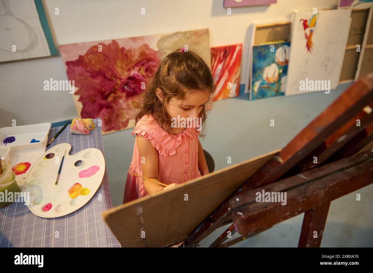 Young Girl Painting During Art Class In A Creative Workshop With