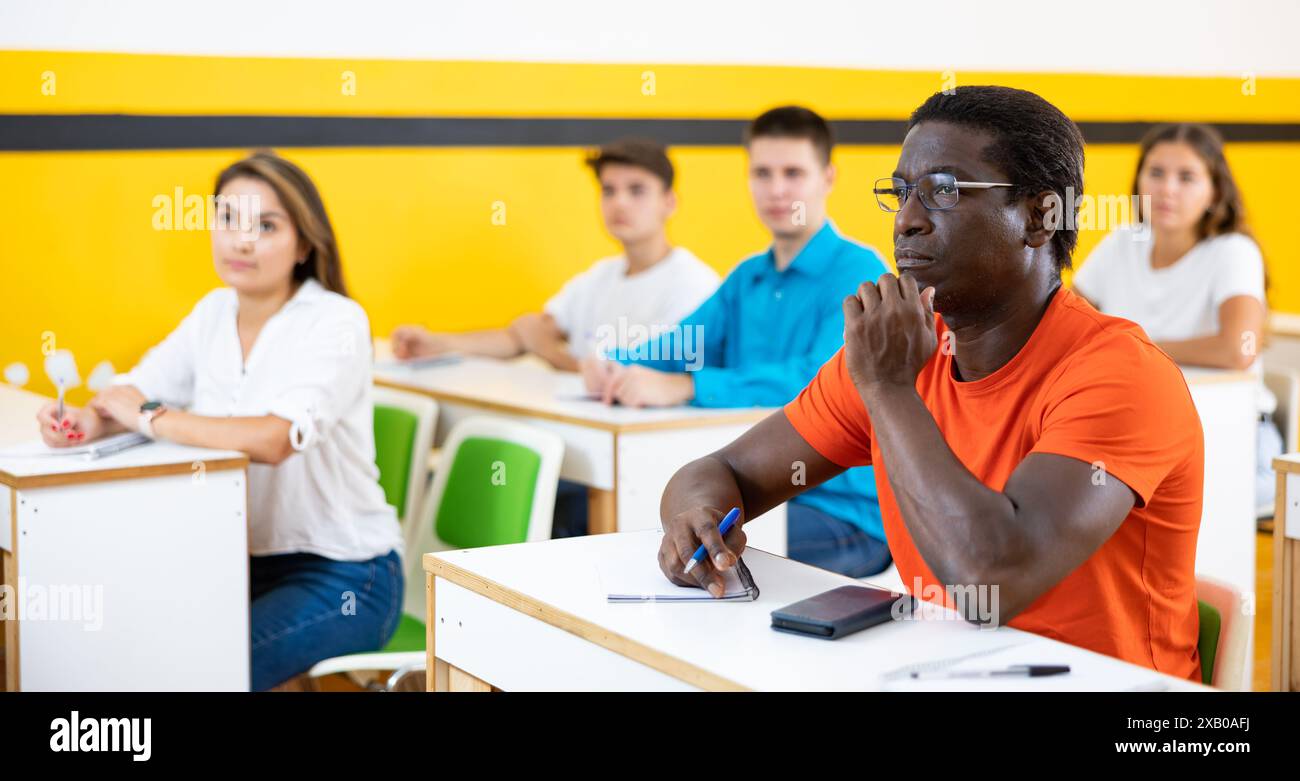 Man attending lecture in taxi training school Stock Photo - Alamy