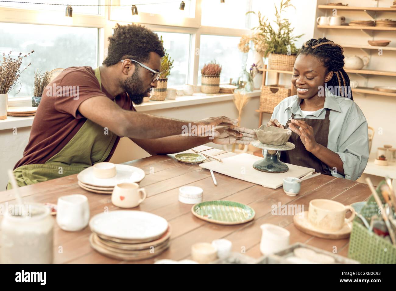 Two people looking involved while working with new pottery Stock Photo ...