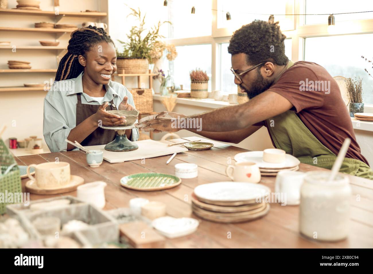 Two people looking involved while working with new pottery Stock Photo ...