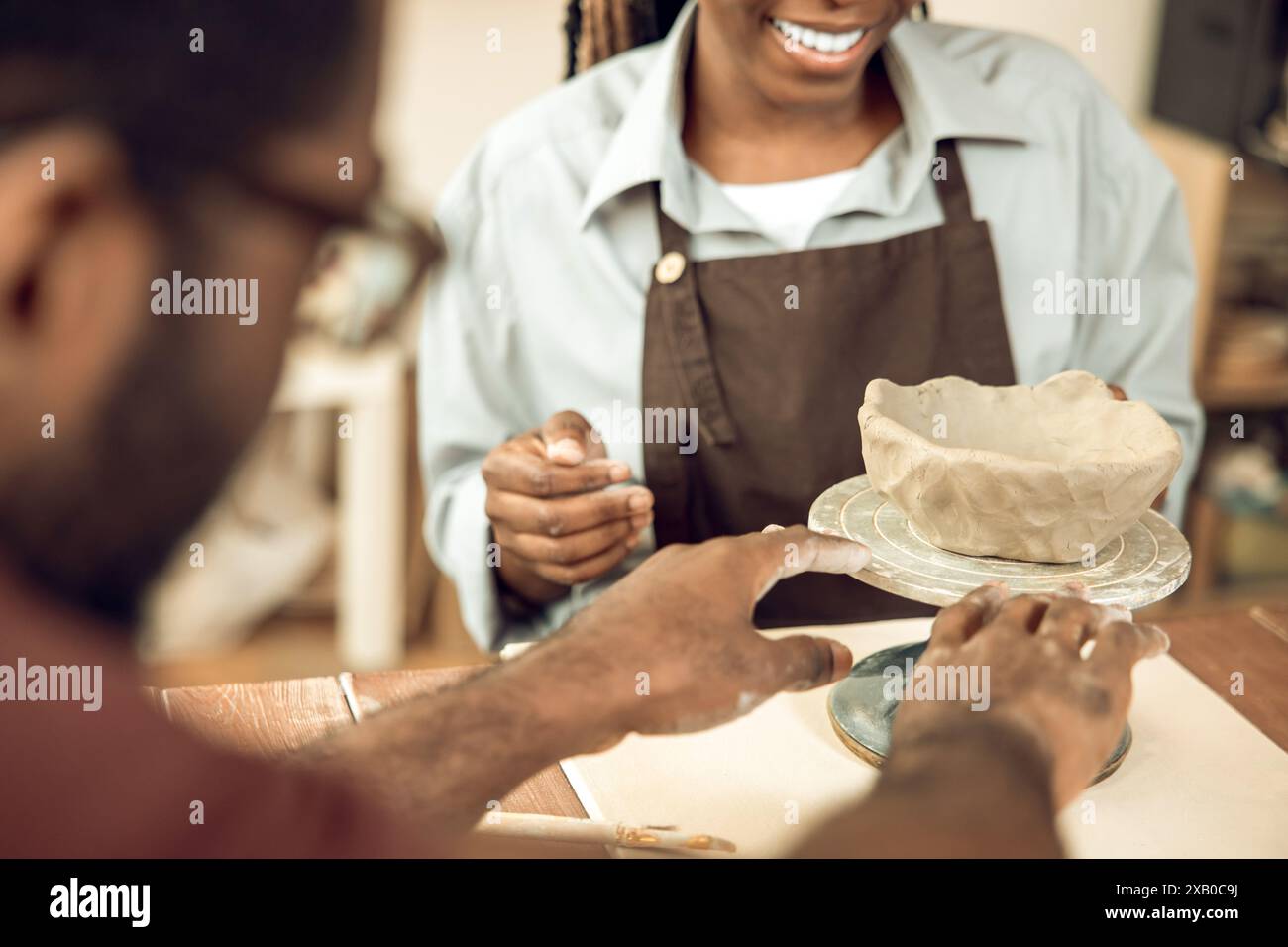 Two people looking involved while working with new pottery Stock Photo ...