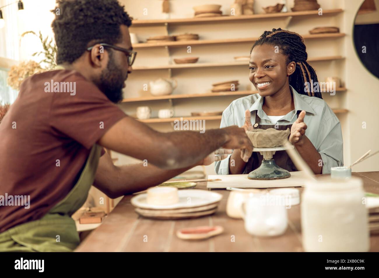 Two people looking involved while working with new pottery Stock Photo ...