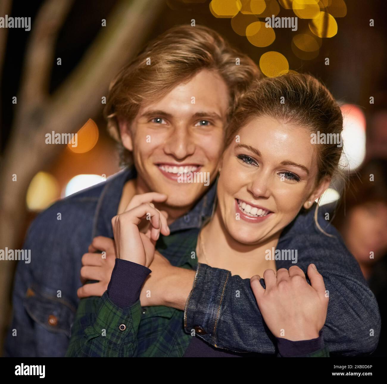 Portrait, smile and couple hug on night date out in the city together ...