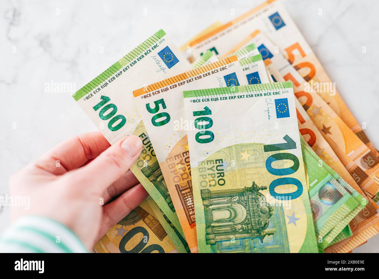 Counting money.one hundred euro banknote in hand. counting Euro bills ...