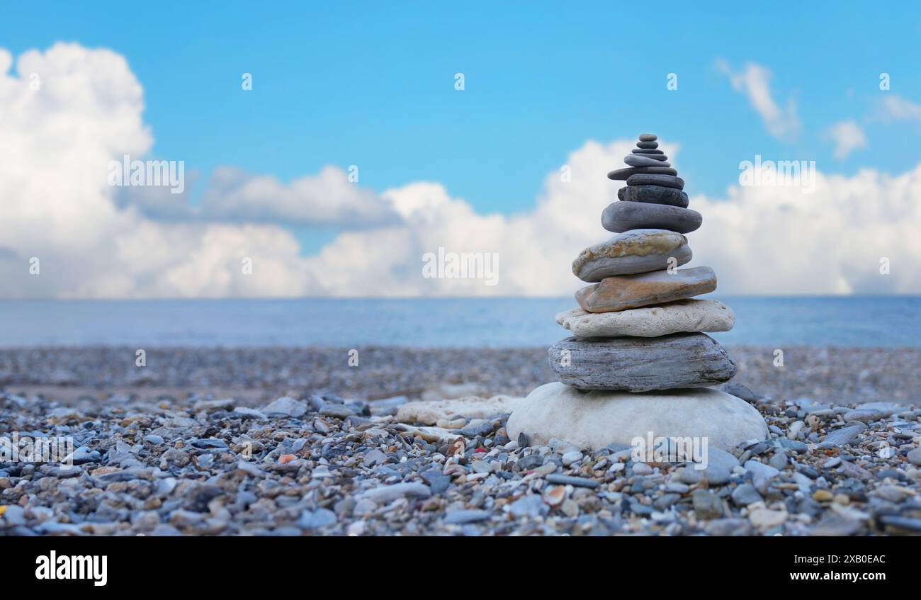 Sandstone are stacked into a pyramid shape on sea and cloud background ...