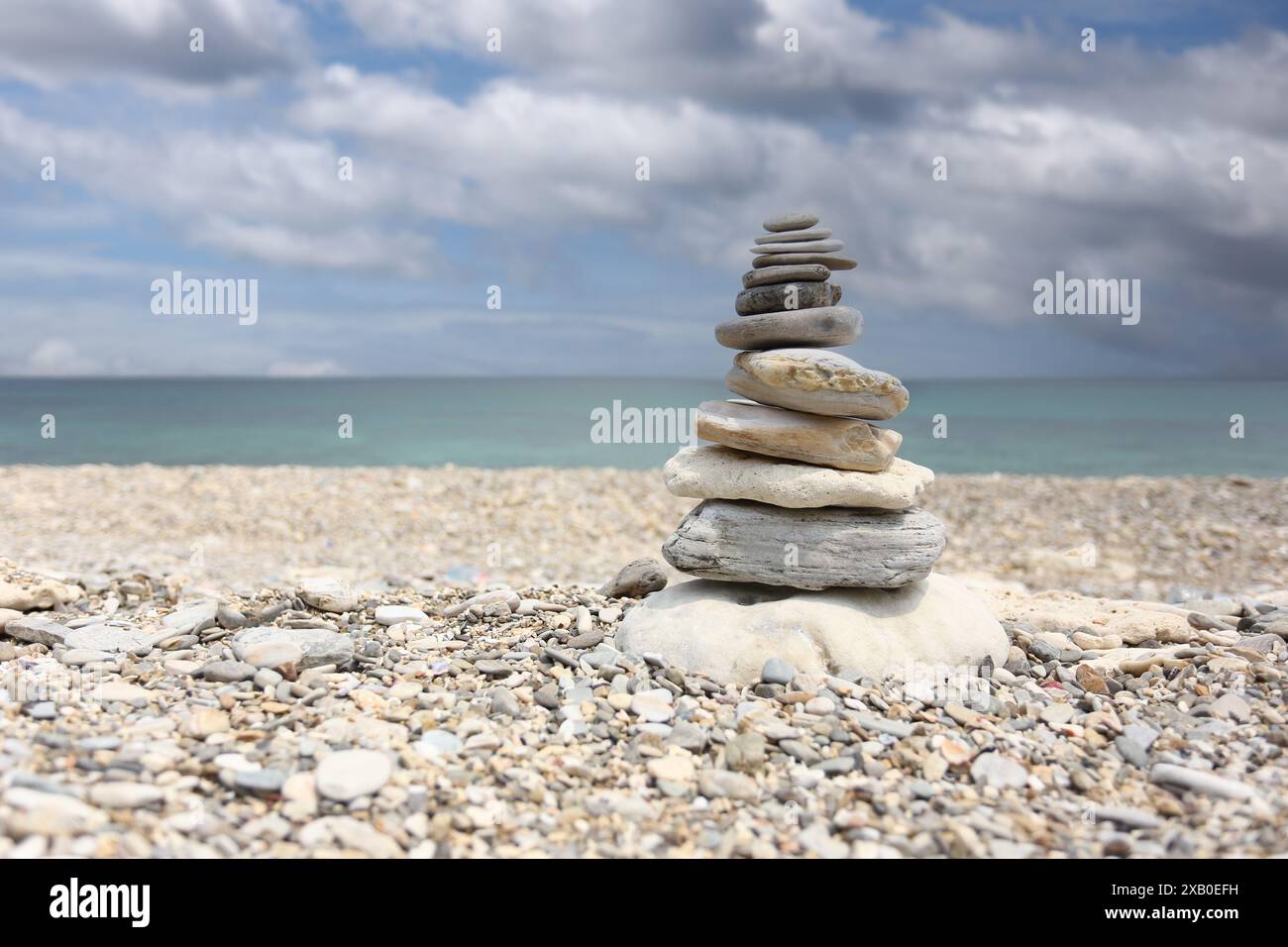 Sandstone are stacked into a pyramid shape on sea and cloud background ...