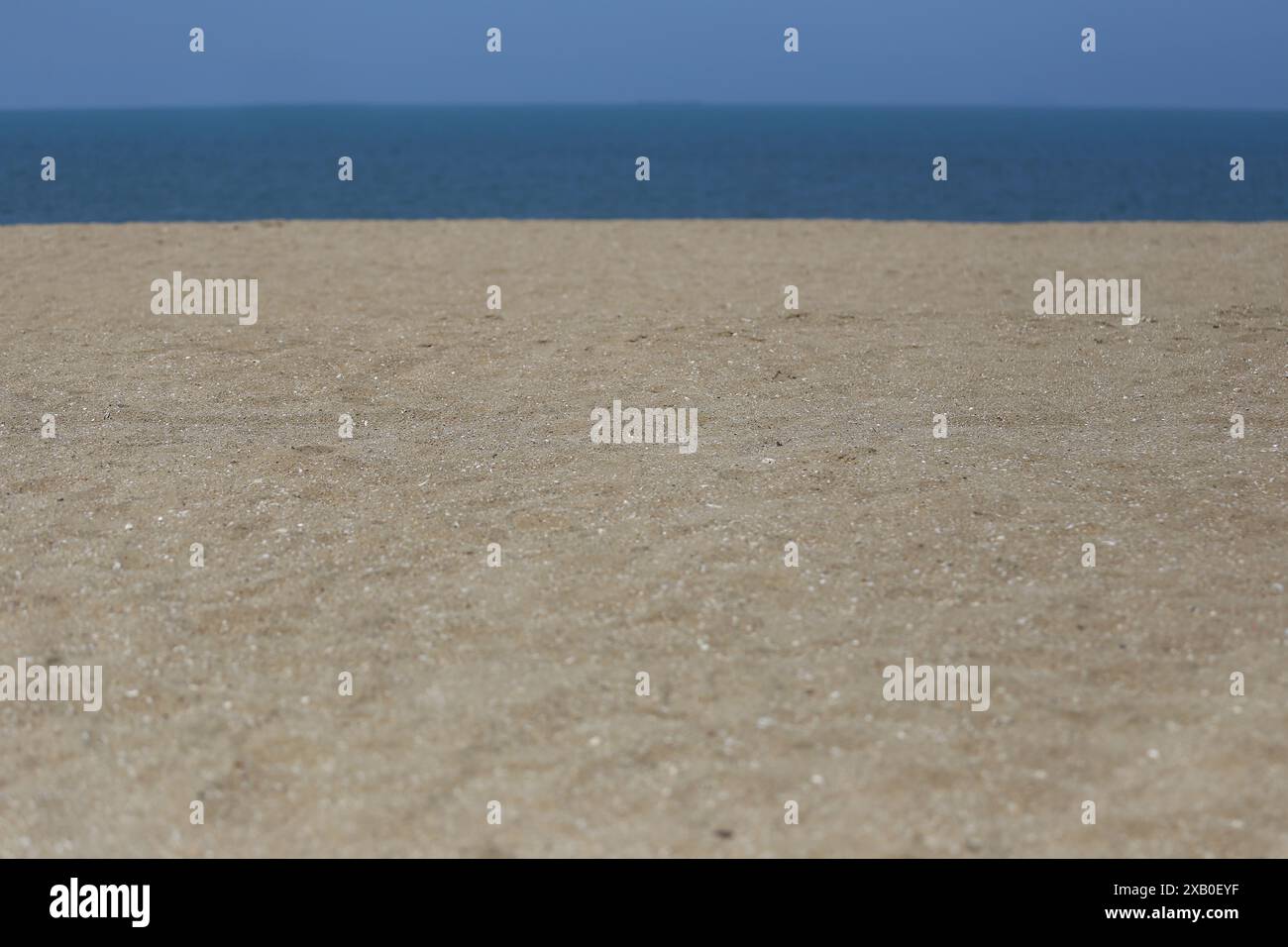A beach with lots of sand and a backdrop of blue sky and sea,Beautiful ...