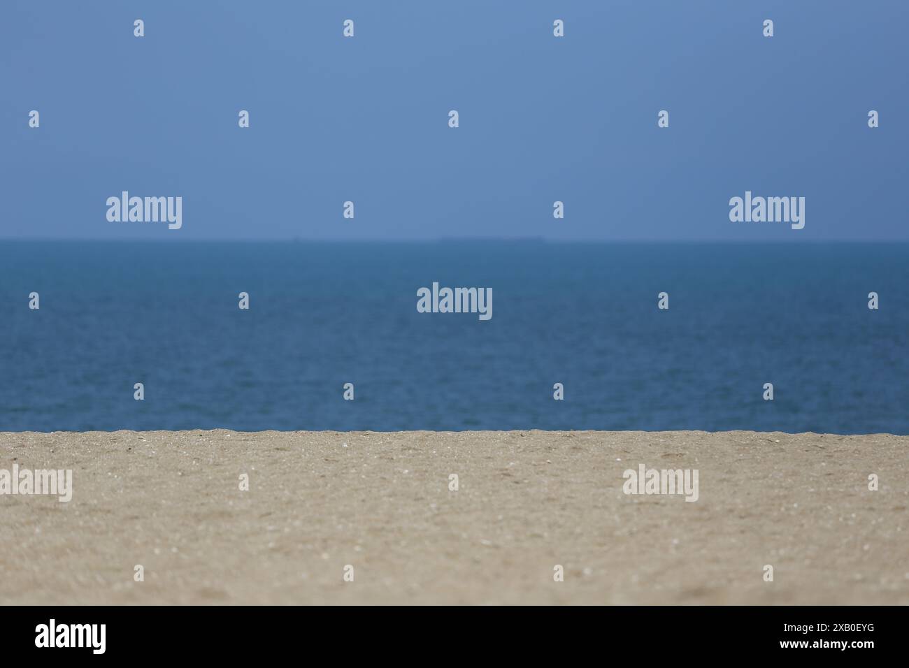 A beach with lots of sand and a backdrop of blue sky and sea,Beautiful ...