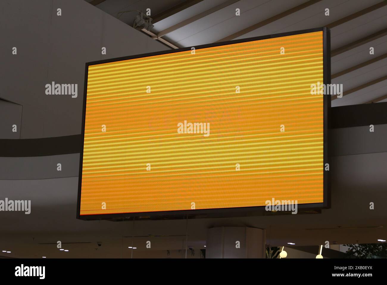 A large TV or projector screen with an orange background in screen ...