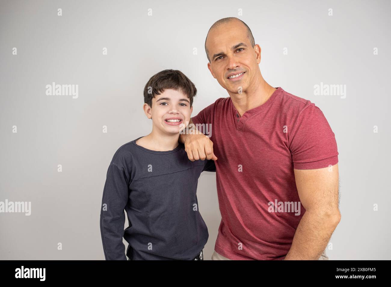 Father and son hugging and smiling looking at the camera. Photos in ...