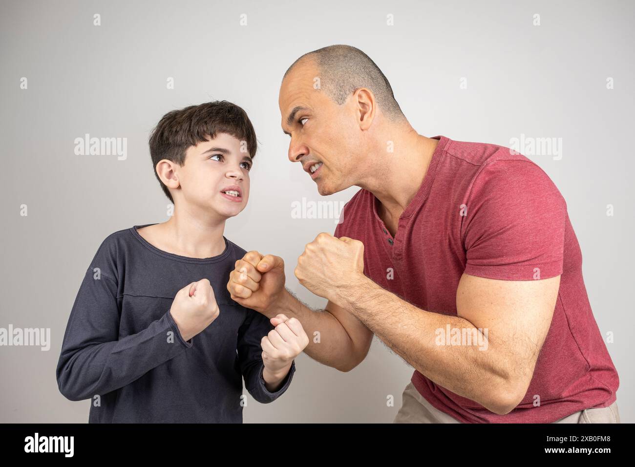 Father and son playing face-to-face fight. Studio photo Stock Photo - Alamy