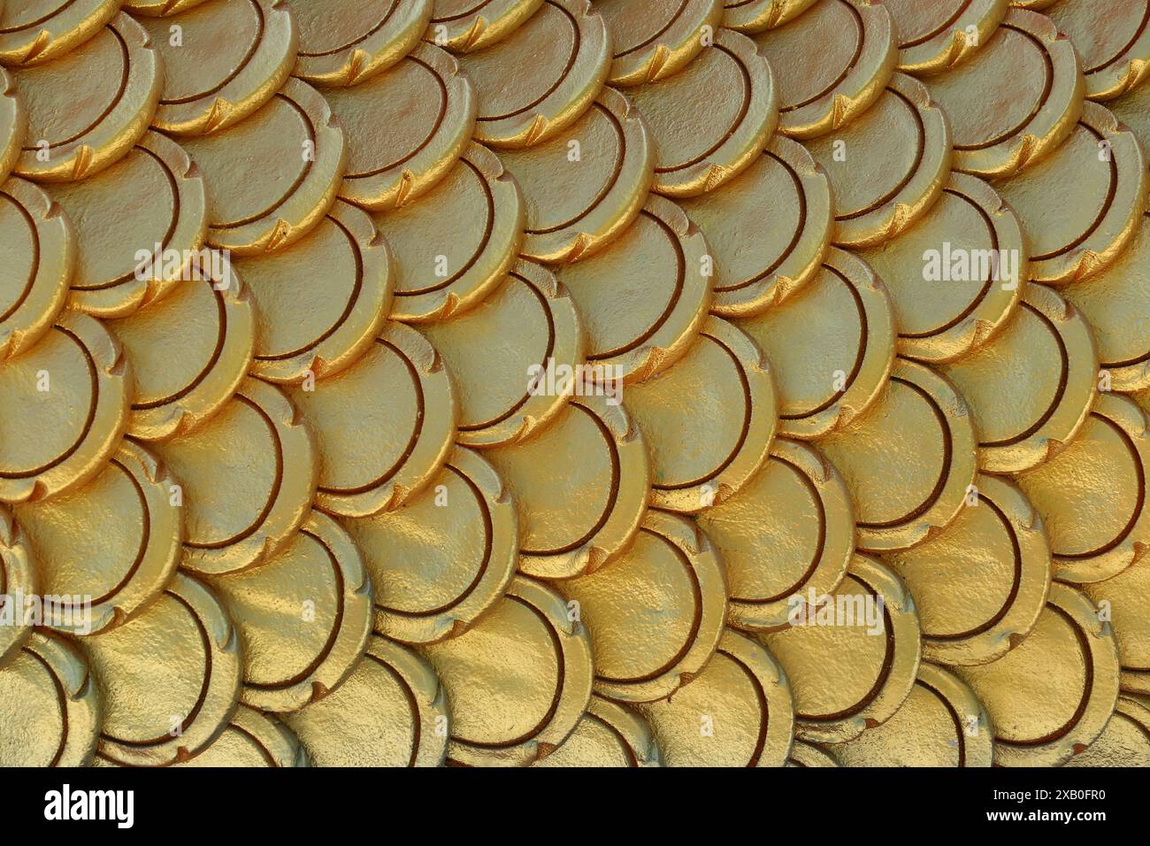 Gold patterns of stucco shaped like fish scales, Background of stacked ...