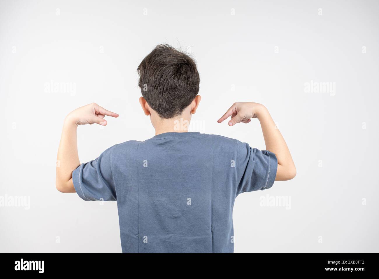 10 year old Brazilian child with his back turned and pointing at his ...