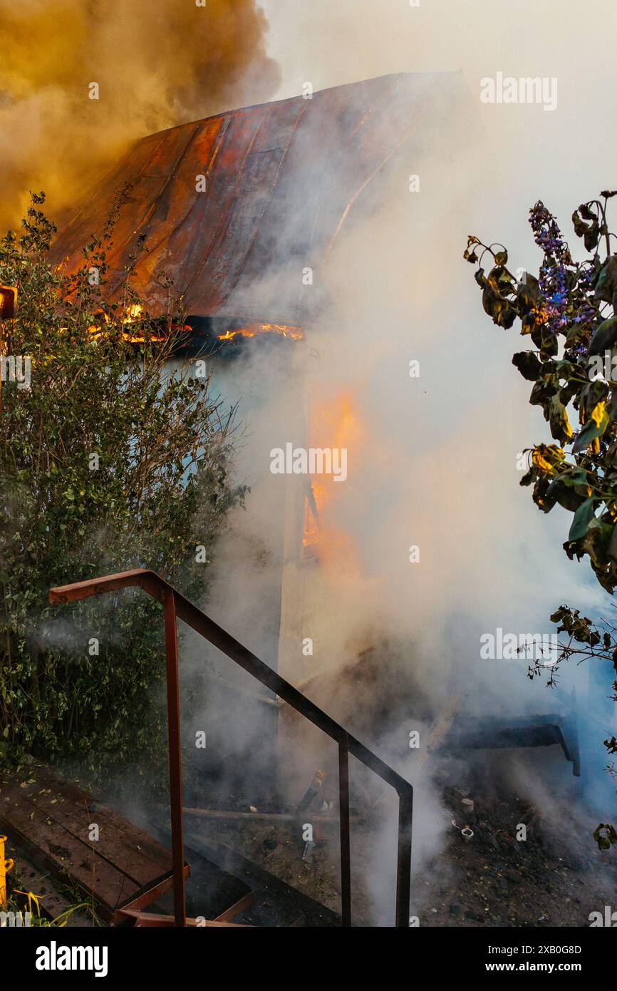 Rural house is burning in fire Stock Photo - Alamy