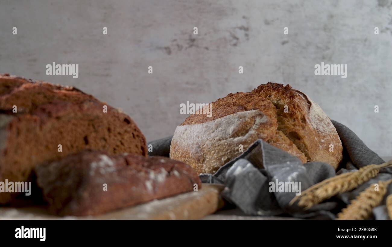 Artisan bread loaves on a rustic table, a warm bakery scene Stock Photo ...