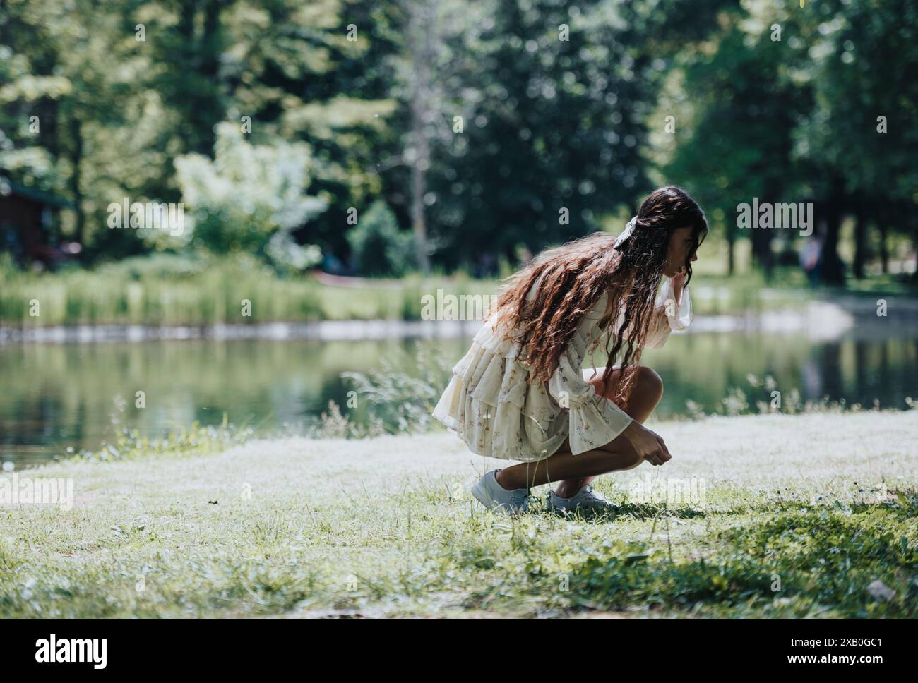 Carefree young woman enjoying a lovely spring day in the park, sunlight ...